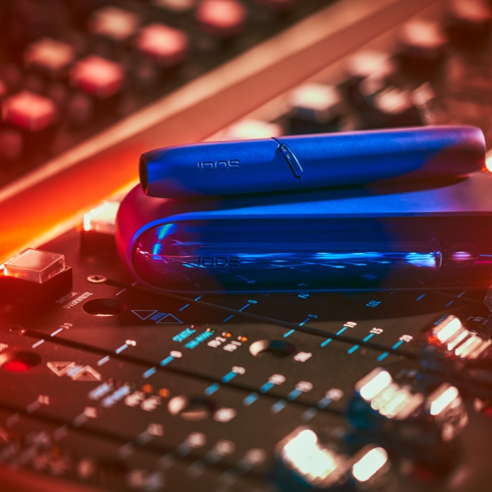 A blue IQOS kept on musical instrument